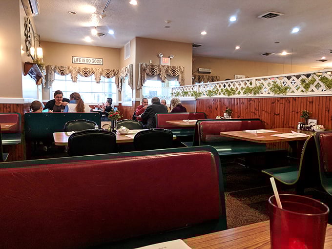 Red booths and wooden accents create that perfect "remember when restaurants felt like this?" atmosphere. Note the "Life is Good" sign &ndash; they're not wrong.