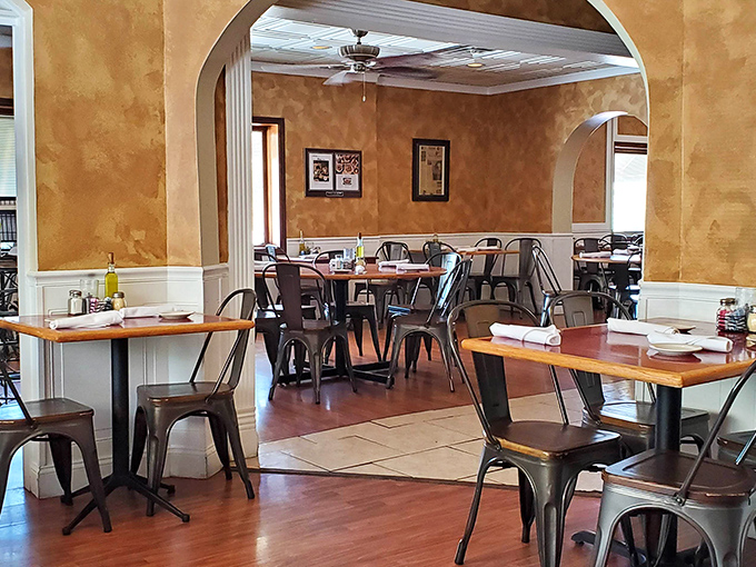 Warm faux-finished walls and elegant arches create dining spaces that feel intimate yet spacious&mdash;like being hugged by architecture with an Italian accent.