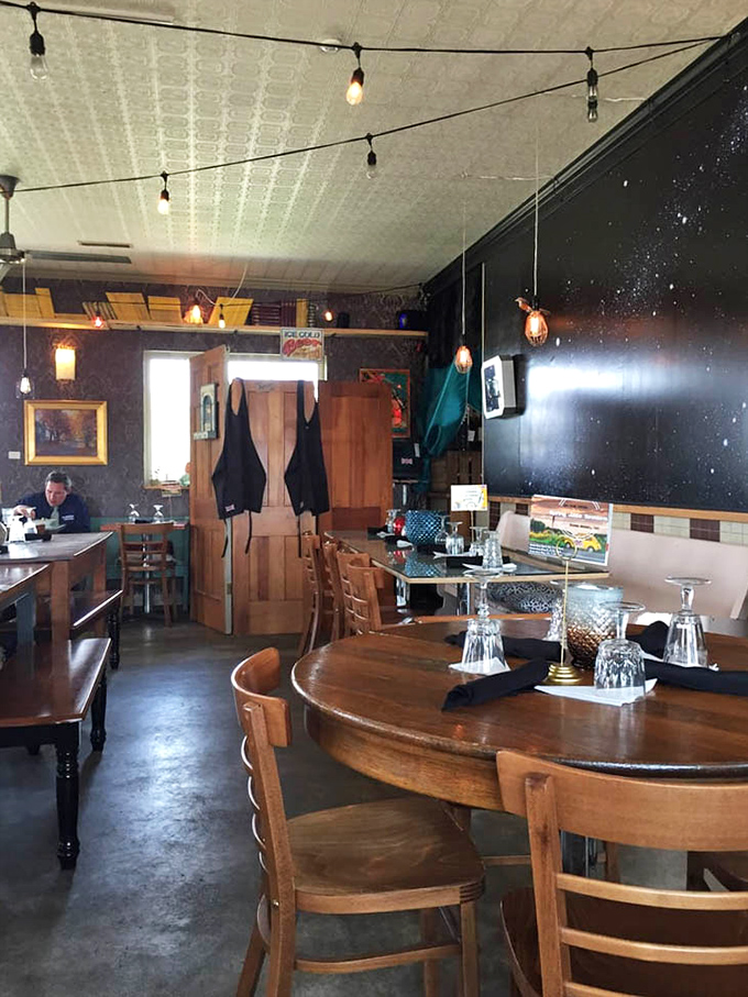 String lights cast a warm glow across this dining area, where every table feels like the best seat in the house.