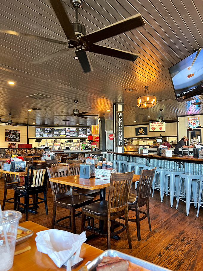 Modern rustic done right—wooden tables meet corrugated metal in a space where comfort and style shake hands over plates of brisket.