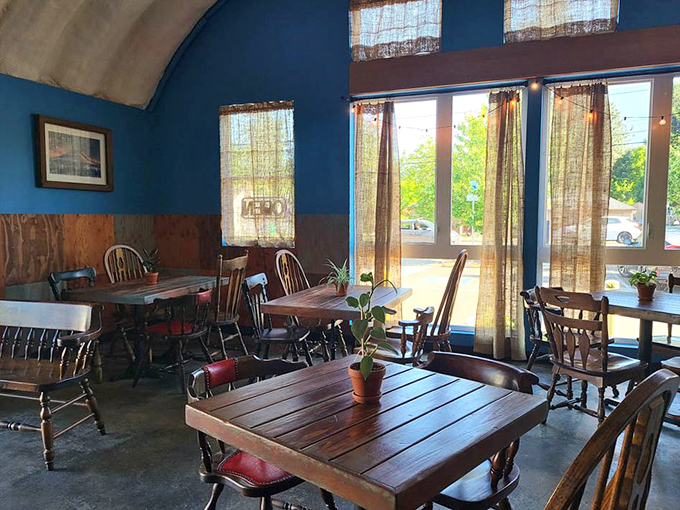 Morning light streams through sheer curtains, illuminating wooden tables where barbecue dreams come true. Simple potted plants add homey touches.