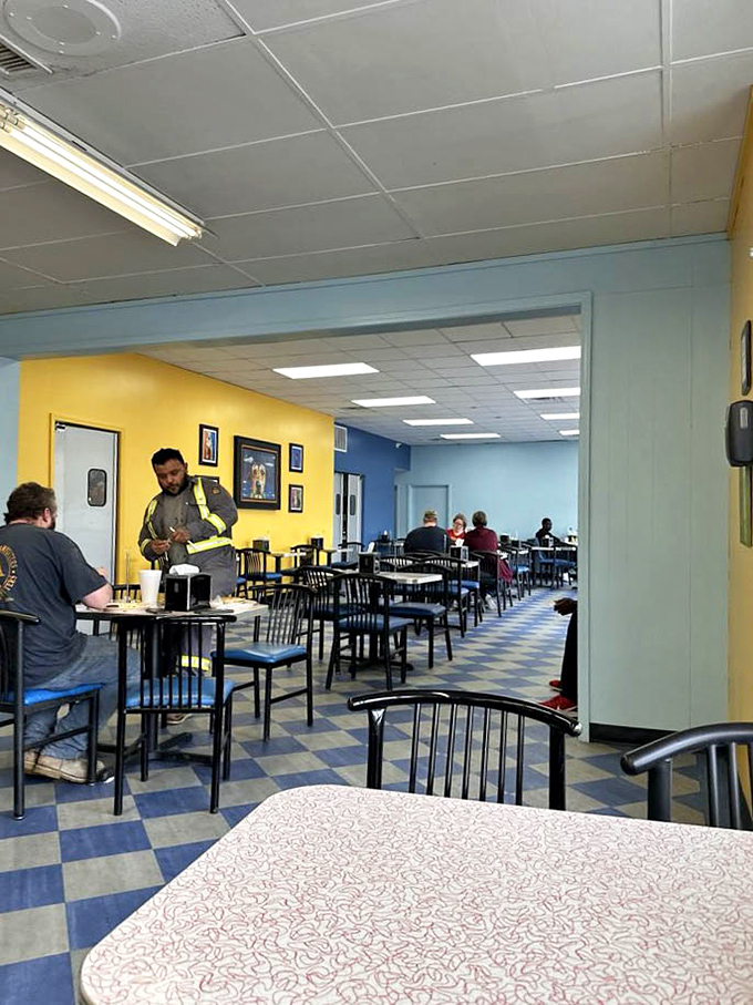 Bright yellow walls and blue accents create a cheerful backdrop for serious eating. Notice nobody's looking at their phones&mdash;the food demands full attention.