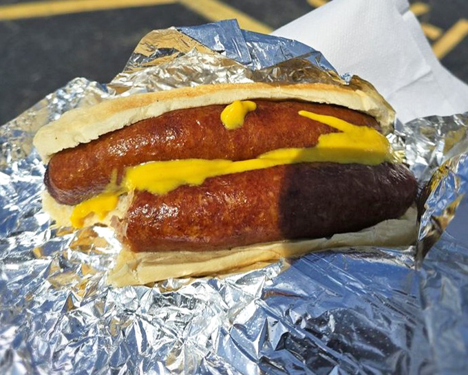 Two sausages with mustard &ndash; proof that sometimes the simplest combination creates the most profound flavor experience. Yellow mustard never had it so good.