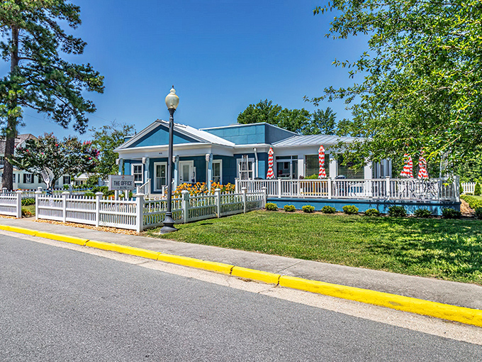 This blue-trimmed cottage with its pristine white fence practically begs you to sit on the porch with something cold and refreshing.