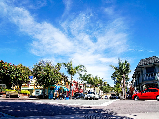 Sunlight floods Capitola's village streets, where palm trees and colorful storefronts create the perfect setting for an afternoon of leisurely exploration.