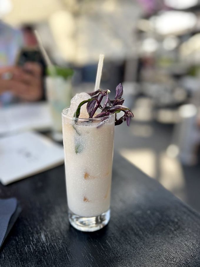 Their signature cocktail arrives looking like a botanical garden in a glass&mdash;complete with purple basil garnish.
