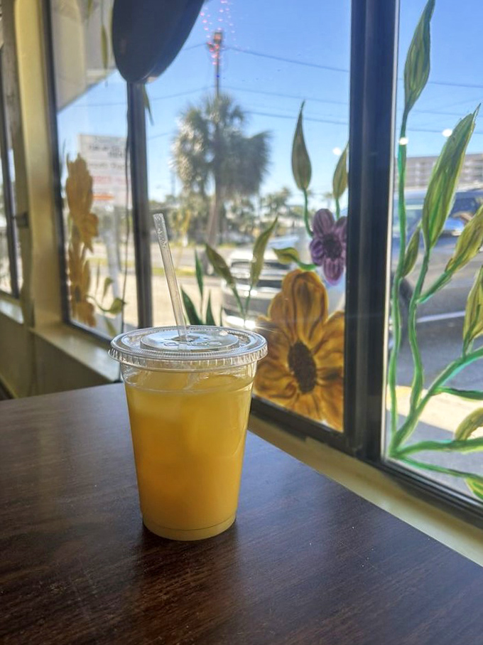Fresh-squeezed orange juice catching Florida sunshine through hand-painted window flowers. Vitamin C never looked so inviting or so perfectly Floridian.