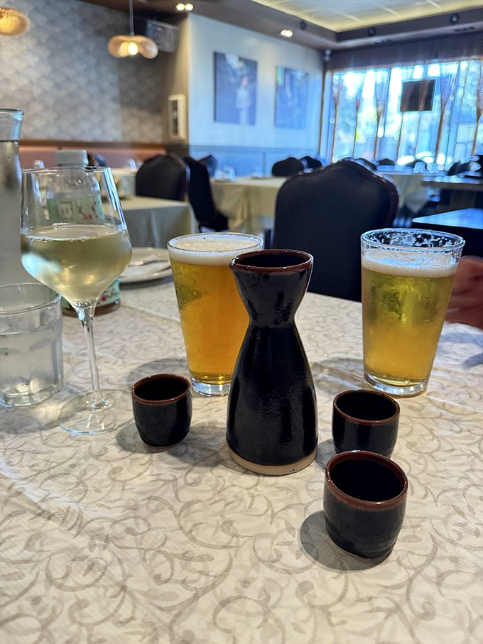 The perfect beverage lineup: cold beer, crisp wine, and sake served in traditional style&mdash;liquid companions for your seafood adventure.