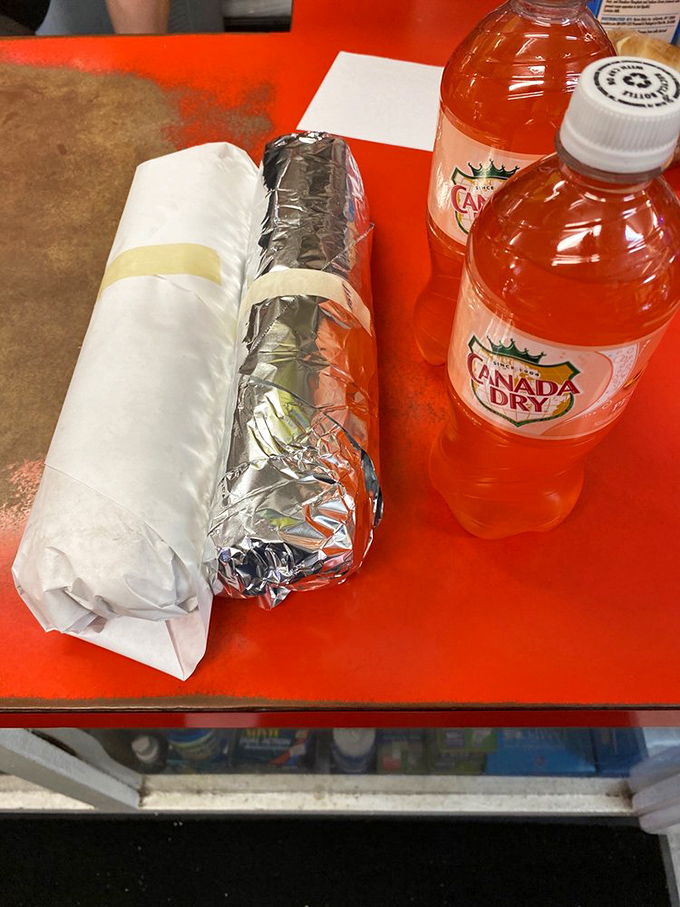 The classic pairing: wrapped sandwich treasures alongside Canada Dry &ndash; proof that some traditions need no improvement.