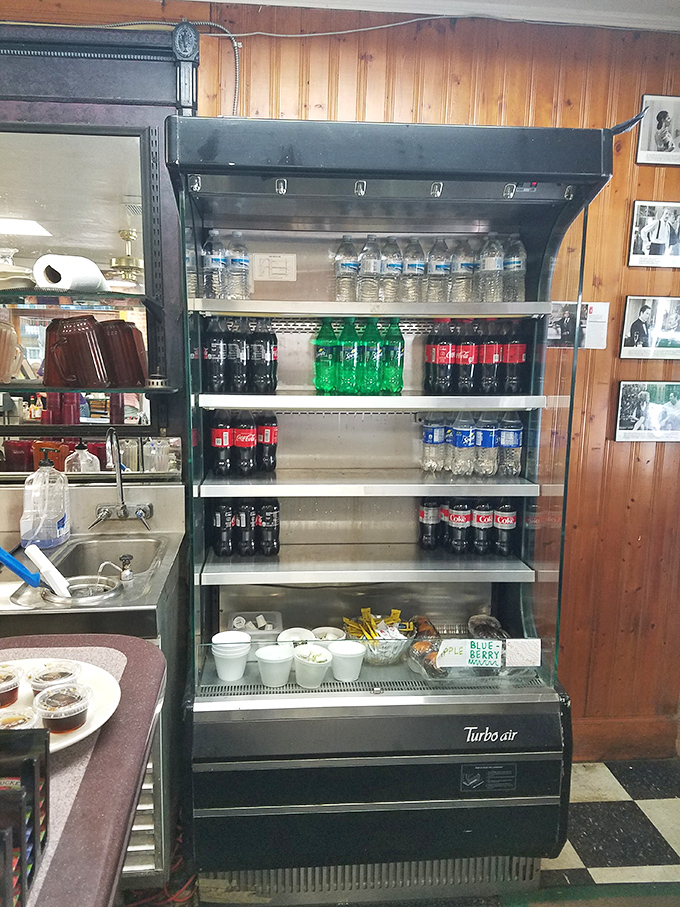 The drink cooler stands ready like a hydration station for the breakfast marathon ahead. Sometimes a cold soda with breakfast feels deliciously rebellious.