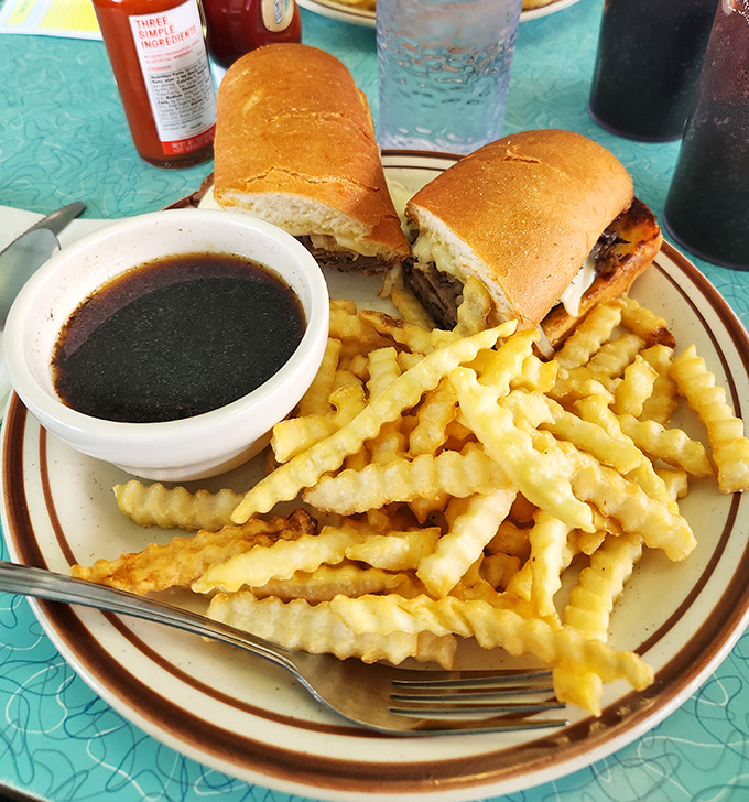 The French Dip sandwich with its side of savory au jus isn't just lunch &ndash; it's an interactive eating experience that rewards proper dipping technique.