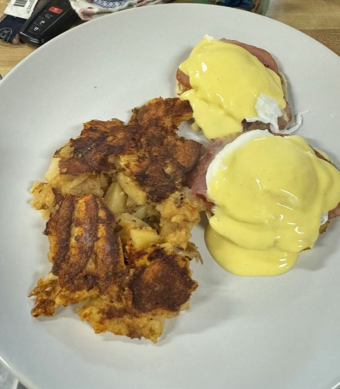 Eggs Benedict lounging on English muffins, hollandaise flowing like liquid gold over perfectly poached orbs of deliciousness.