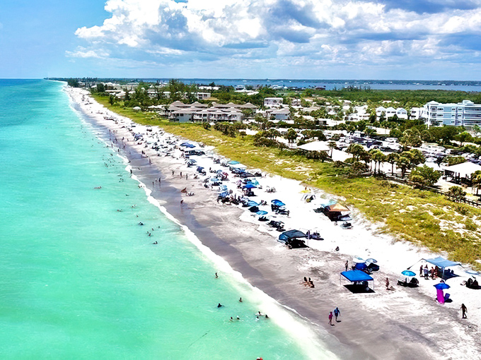 Englewood Beach stretches out like nature's welcome mat, where umbrellas create a patchwork quilt of vacation dreams.