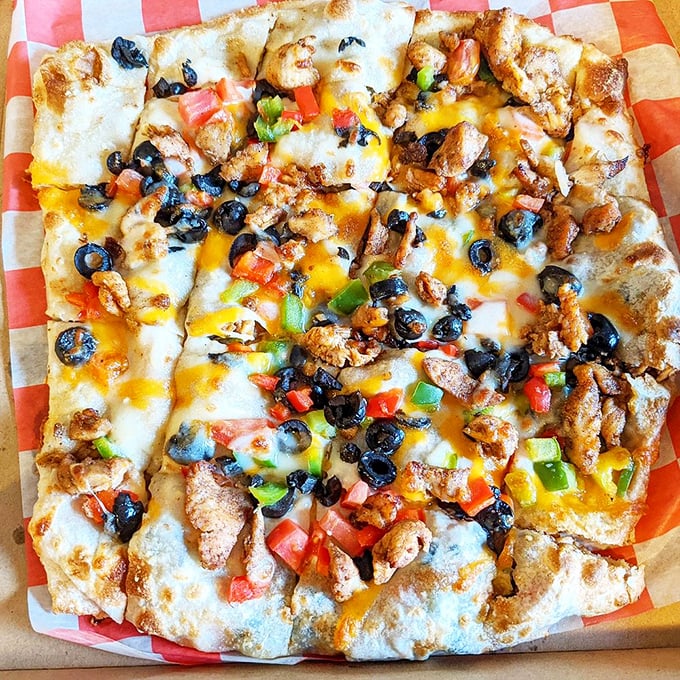 Feteer sharqi flatbread arrives looking like edible art, topped with olives and cheese in beautiful harmony. 