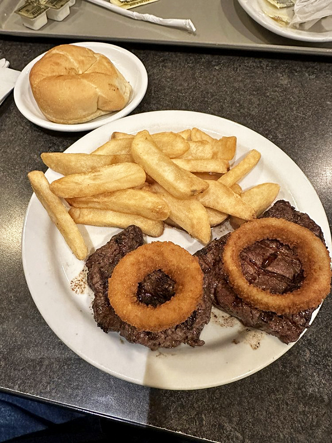 The steak and onion rings platter&mdash;where beef meets its crispy circular companions in a relationship your cardiologist warned you about.
