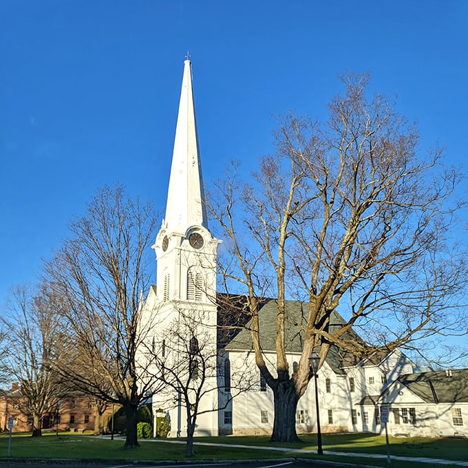 The First Congregational Church stands tall like a benevolent guardian of the town. That spire has witnessed centuries of Manchester life unfolding below.