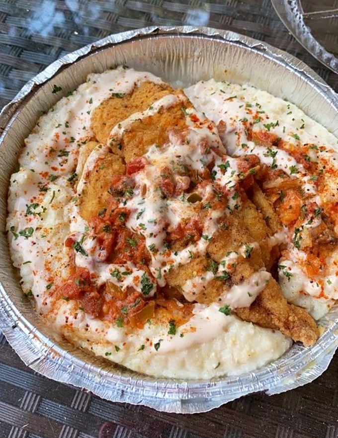 Fish over creamy grits with all the fixings&mdash;Southern comfort food that makes you understand why people write songs about going home.