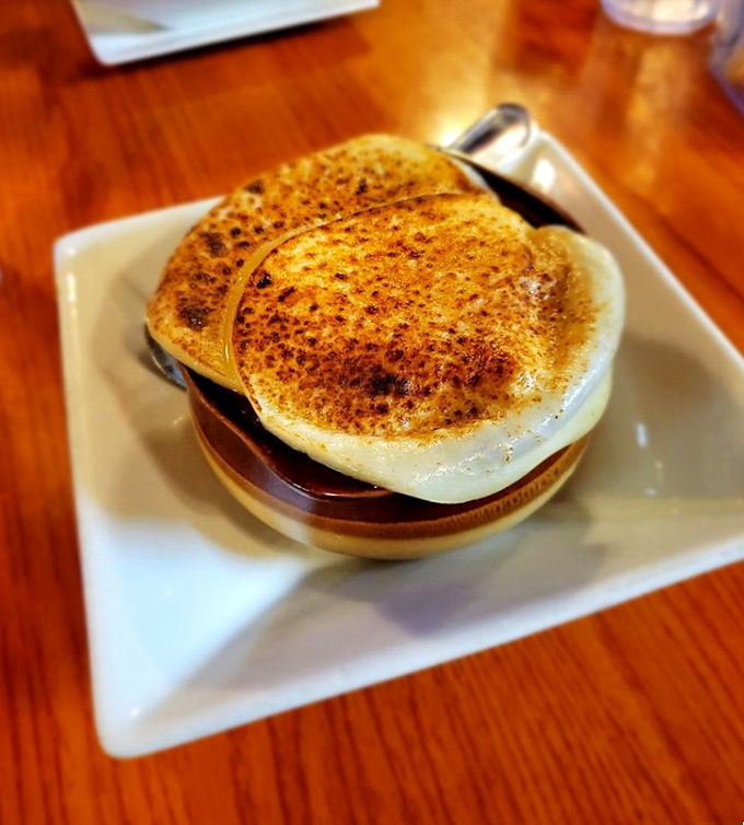 French onion soup with a bronzed cheese cap so perfect it deserves its own Instagram account—comfort food elevated to art form.