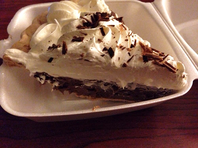 French silk pie with mountains of whipped cream proves that chocolate therapy comes in slice form here.