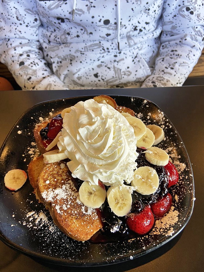 French toast that looks like it graduated from culinary school with honors. Those fresh berries and bananas make it almost too pretty to eat. Almost.