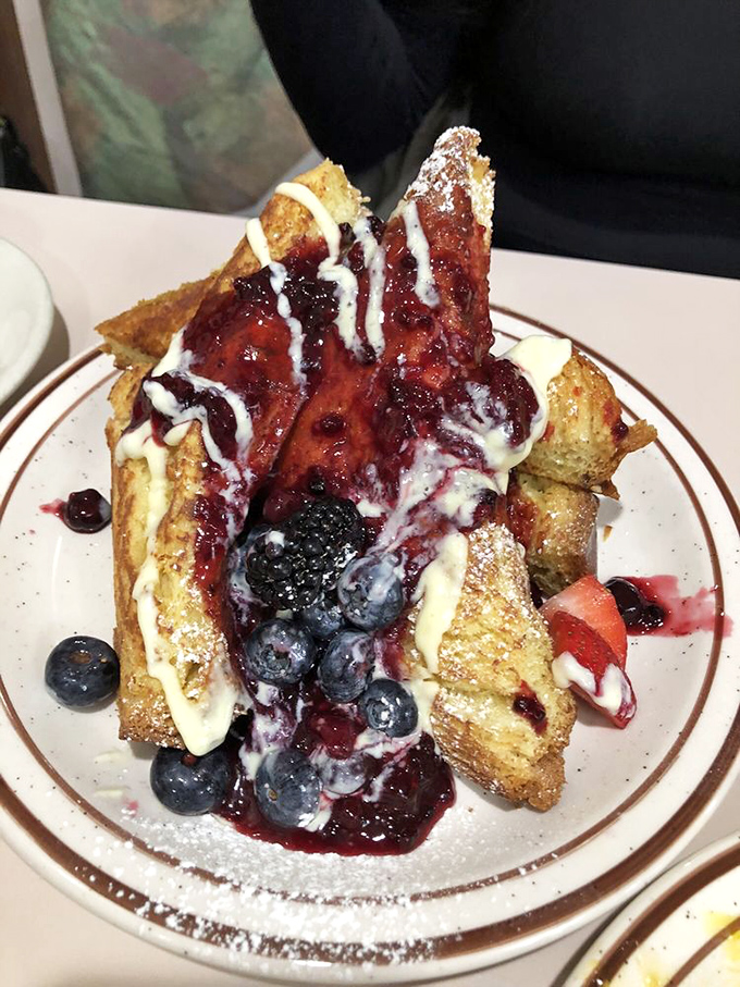 French toast that's crossed the line from breakfast to dessert, yet somehow remains socially acceptable before noon. Berry-topped breakfast bliss that justifies setting alarm clocks.