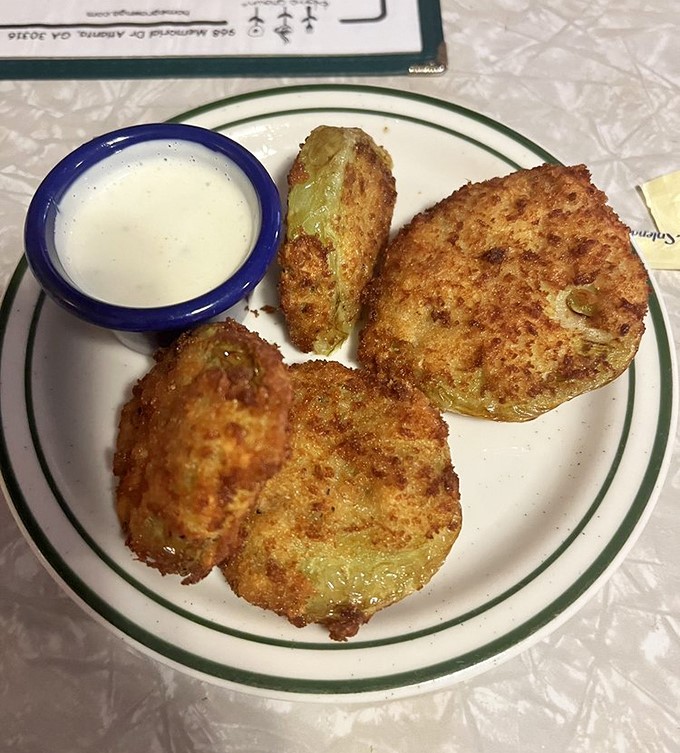 Fried green tomatoes that achieve the impossible: crispy exterior, tangy interior, and a dipping sauce that makes you consider drinking it straight.