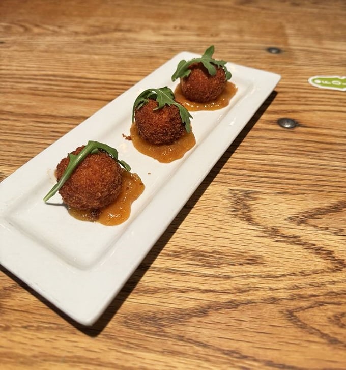 These aren't just any fried balls&mdash;they're crispy grits transformed into golden orbs of Southern comfort, each one a perfect three-bite journey.