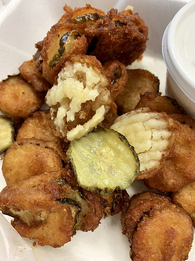 The fried pickles arrive looking like golden poker chips from a casino where everyone wins the jackpot of tangy, crunchy satisfaction.