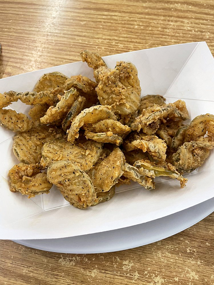 Fried pickles that achieve the impossible: maintaining their crunch while delivering that perfect vinegary tang. Your french fries are jealous.