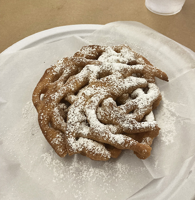 A sweet finale: funnel cake dusted with powdered sugar. Because sometimes after wrestling with crabs, you deserve a little carnival-inspired indulgence.