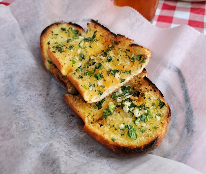 Garlic bread that doesn't whisper but announces its presence &ndash; herbaceous, buttery, and worth every moment of post-meal breath mint necessity.