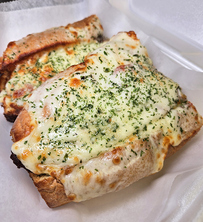 Garlic bread that's more than an afterthought &ndash; it's a cheese-blanketed carb canvas that makes waiting for your pizza a pleasure, not a chore.