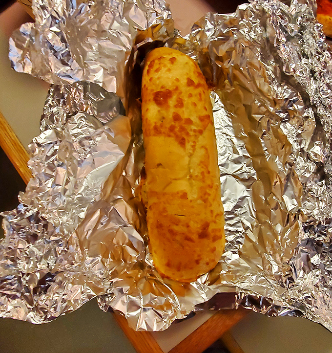 Garlic bread that's achieved the golden ratio of crisp exterior to soft interior, with cheese that stretches like it's training for the Olympics.