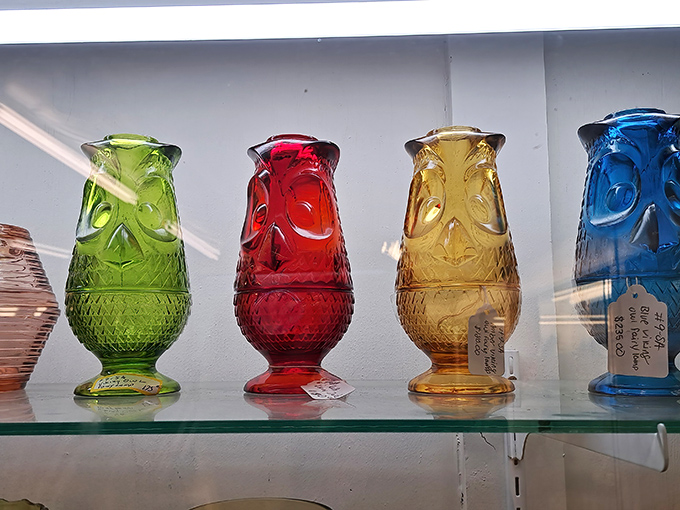 Colored glass vases catch light like liquid jewels, waiting to brighten someone's windowsill once again.