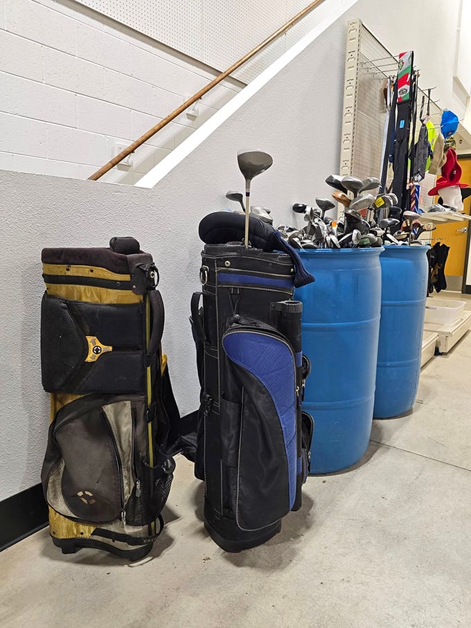 Golf bags stand at attention, holding clubs that have seen more fairways than most of us ever will.