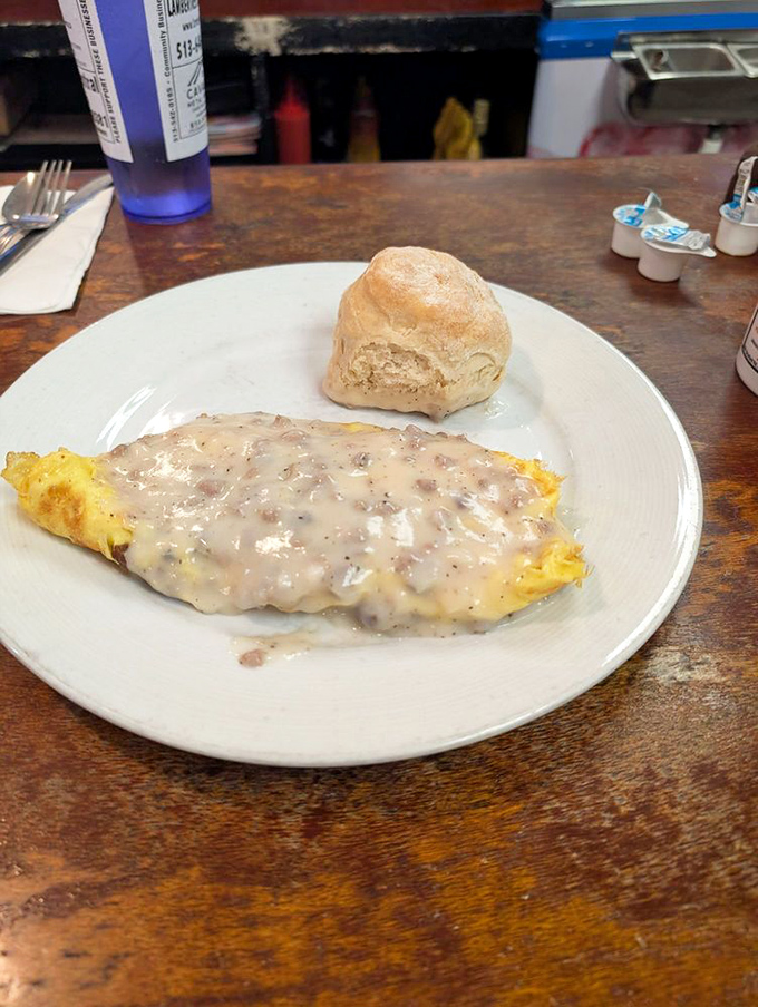 This omelet, smothered in country gravy, isn't just breakfast—it's a commitment, a declaration, a beautiful reason to skip lunch entirely.