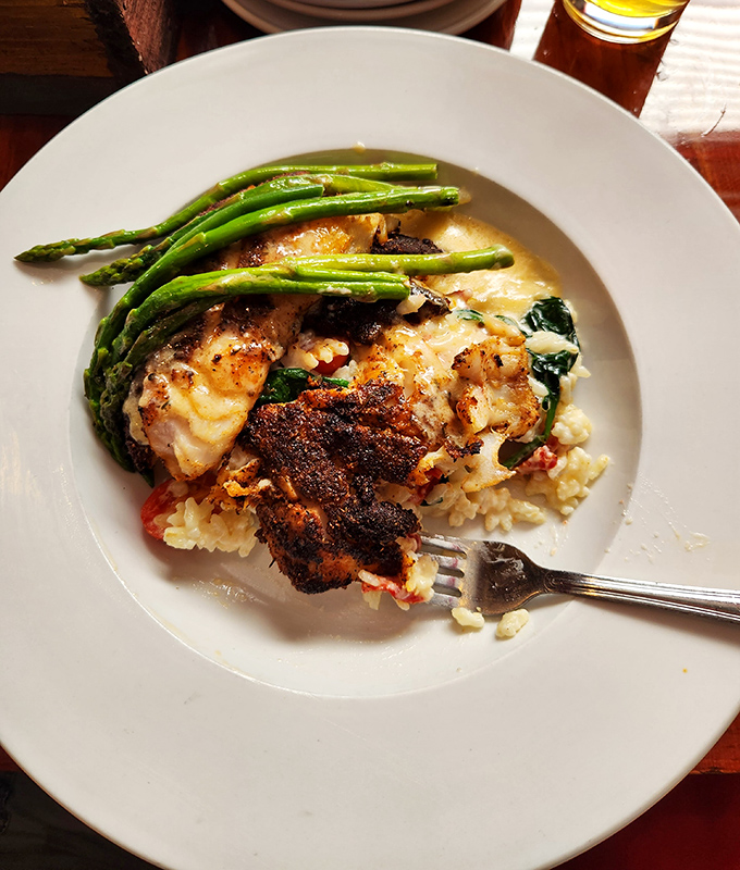 Blackened fish over risotto with a side of asparagus—proof that seafood doesn't always need to be fried to be fantastic.