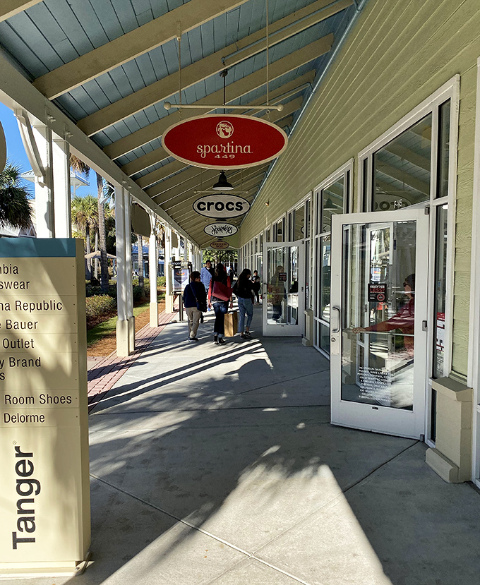 The covered walkways: where South Carolina sunshine meets shopping convenience. Those hanging store signs create a rhythm that somehow hypnotizes you into "just one more store."