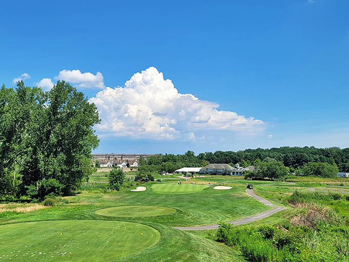 The rolling greens of this golf course unfold like a verdant carpet beneath dramatic Wisconsin skies that seem to go on forever.