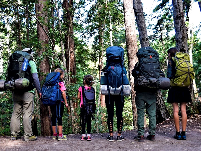 Family adventures take on new meaning when everyone's carrying their worldly possessions on their backs, creating memories taller than the trees themselves.
