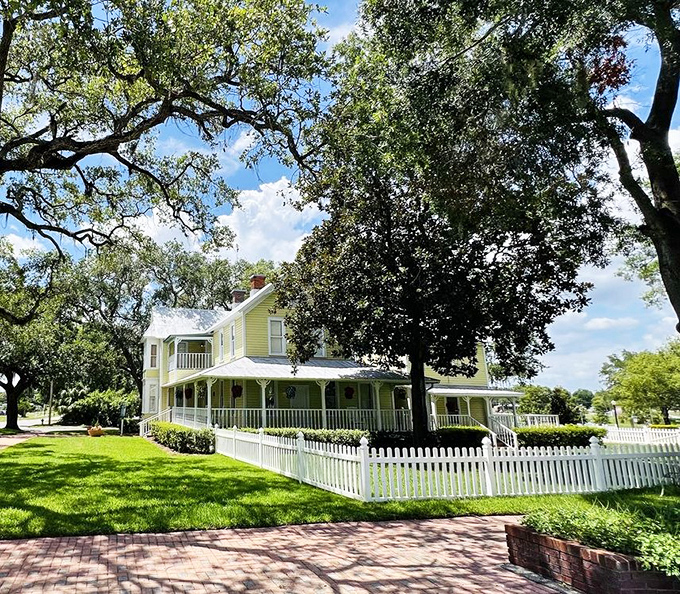 The historic Baynard House stands as elegant today as when it was built, surrounded by oak trees that have witnessed generations of Auburndale stories.