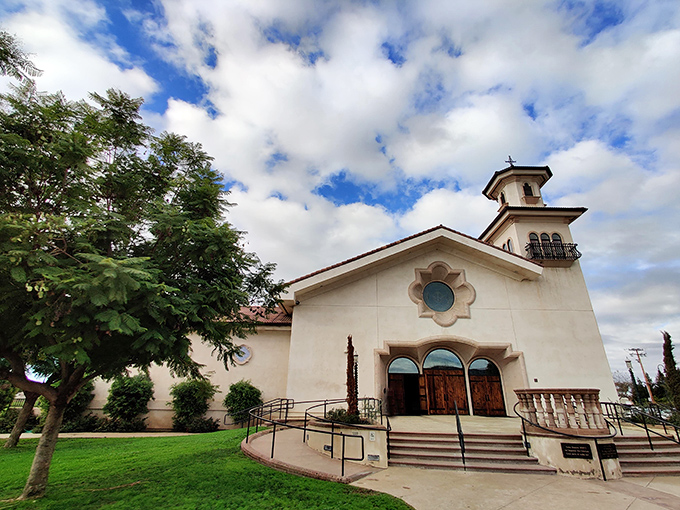 Holy Cross Catholic Church's elegant simplicity stands as architectural poetry against Porterville's blue skies, offering both spiritual and aesthetic elevation.