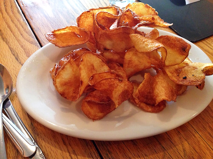 Homemade potato chips that crackle with more personality than most reality TV stars. Each one is a perfect, crispy ambassador of potato perfection.