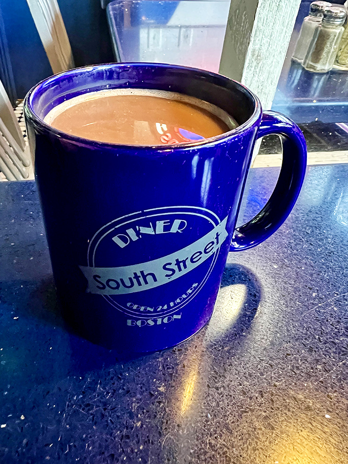 The blue mug isn't just a vessel&mdash;it's a promise that this coffee will actually taste like something worth waking up for.