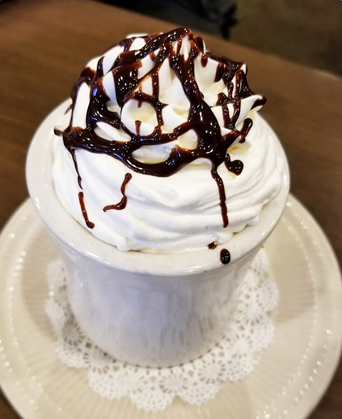 Hot chocolate that's dressed for a special occasion. That whipped cream mountain with chocolate drizzle would make Willy Wonka weep with joy.