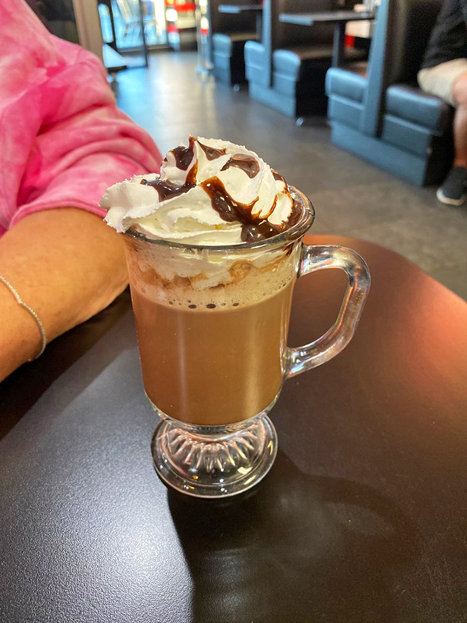 This hot chocolate isn't just a beverage, it's a dessert masquerading as a drink&mdash;topped with whipped cream and chocolate drizzle in a glass mug that means business.