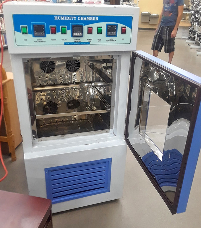 A humidity chamber appears like an alien artifact among household goods &ndash; proof that one person's specialized equipment is another's conversation piece.