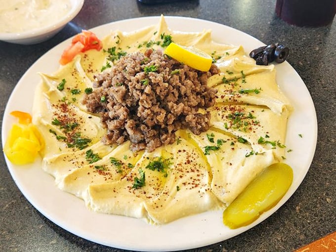 Hummus arranged like edible art, smooth and creamy enough to make you question why you ever bought the grocery store version.