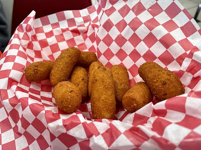 Hush puppies nestled in their checkered paper cradle&mdash;golden-brown orbs of cornmeal joy waiting to be dunked in something delicious.