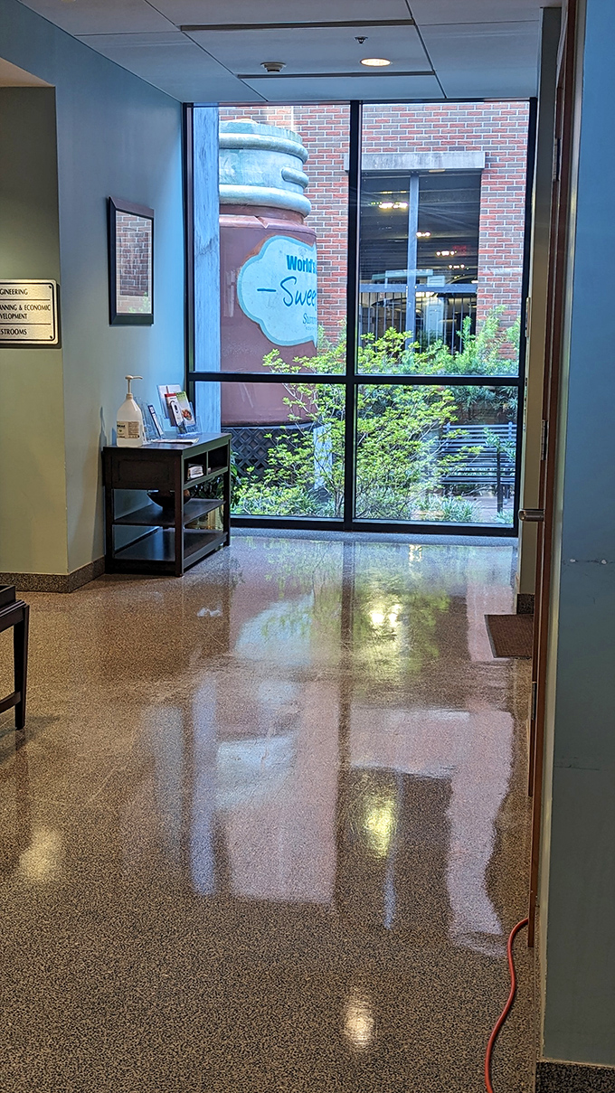 The giant mason jar is so prominent it's visible from inside nearby buildings. "Excuse me, is this office with a view of giant tea available?" 